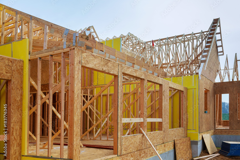Installation of wooden beams at construction of frame house photo of a ...