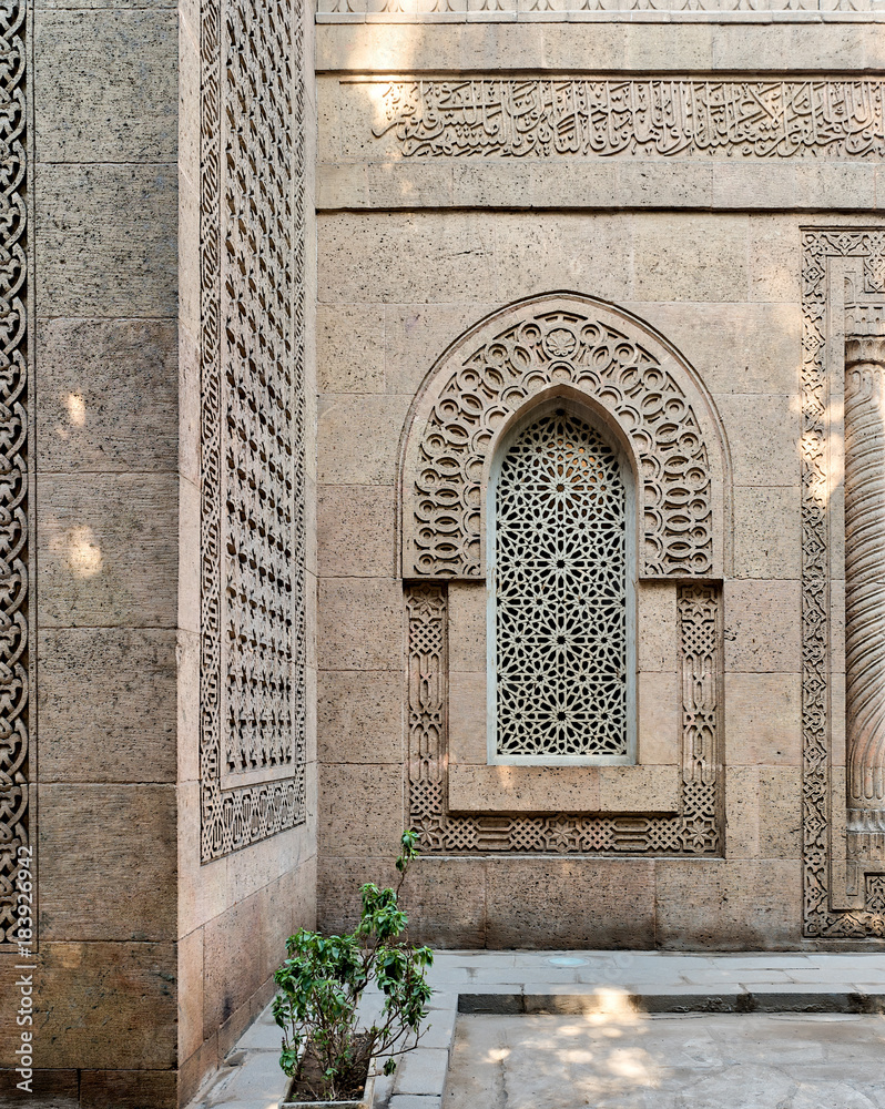 Arched window with grid of ornate marble geometric pattern in the ...