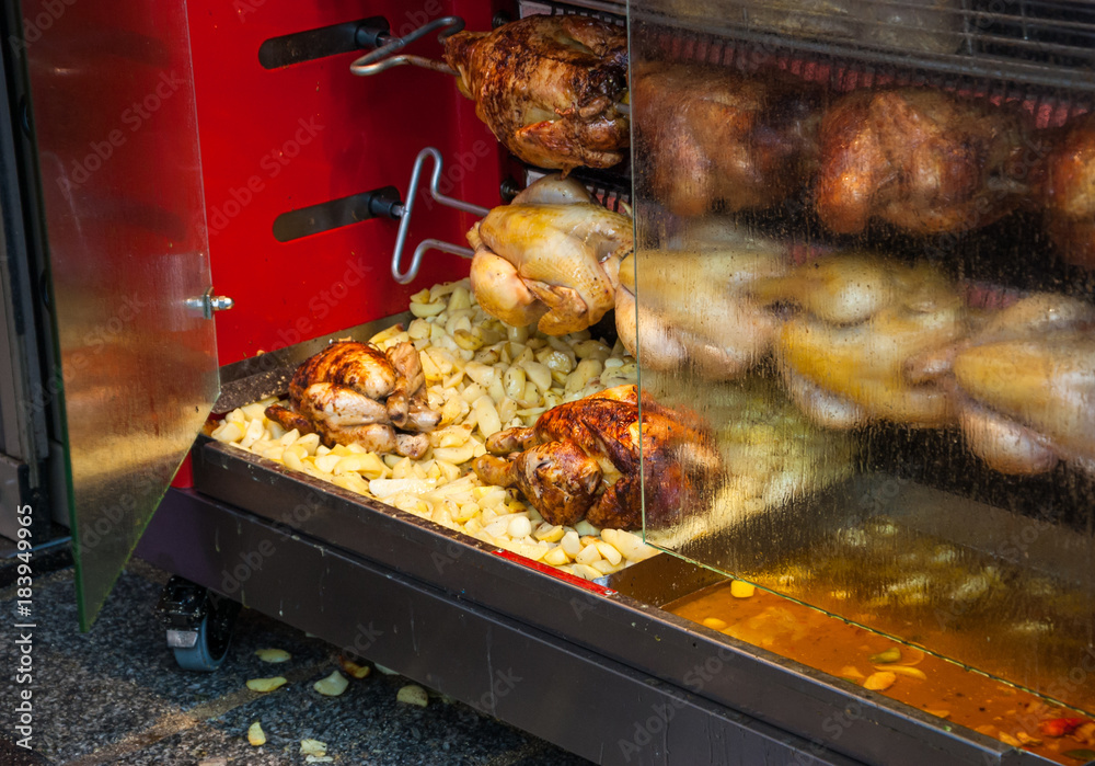 Rotisserie chicken and potatoes near the entrance to the butcher shop ...