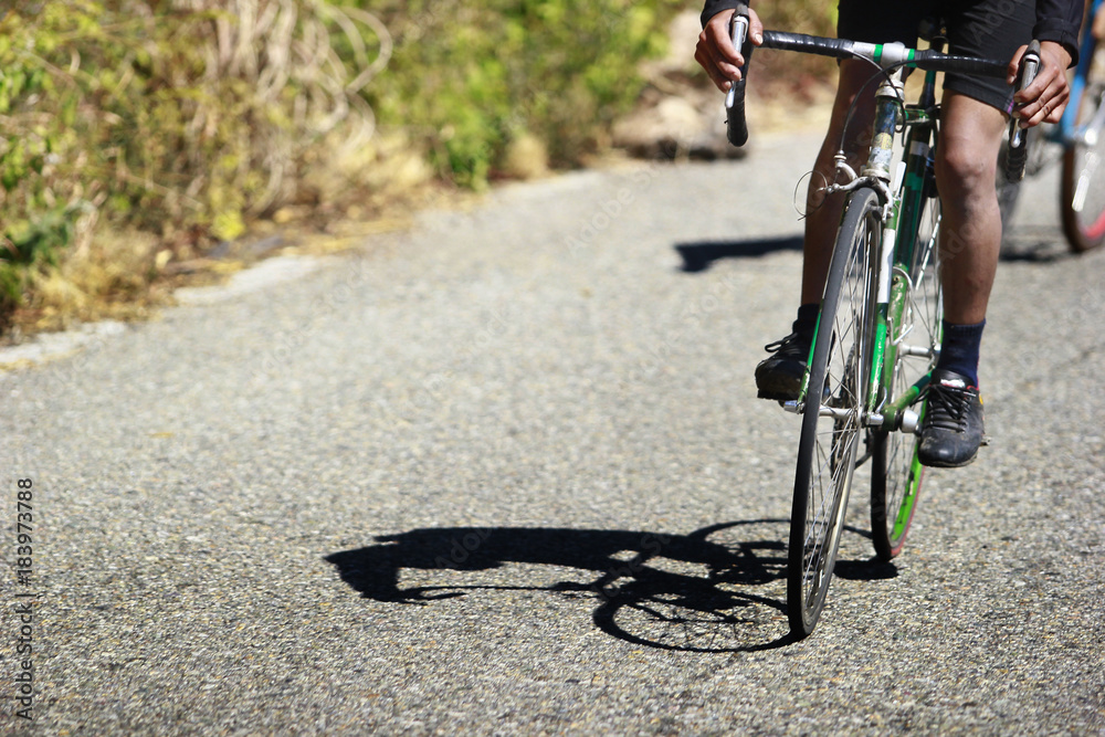 An amateur road cyclist close up, riding a vintage italian road bicycle ...