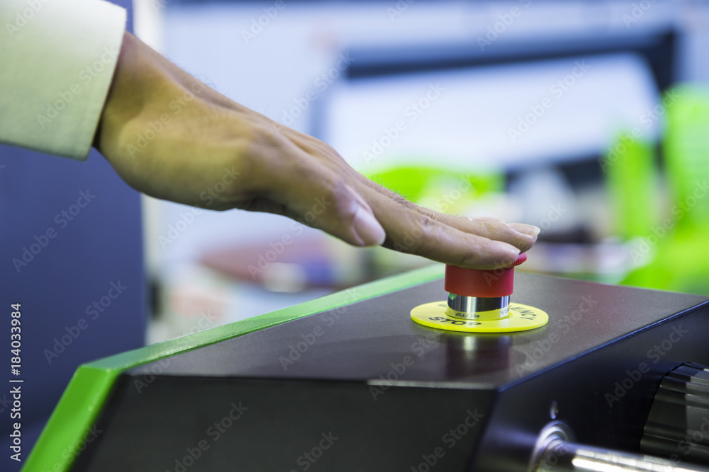 emergency stop button push by finger for stopping machine Stock Photo ...