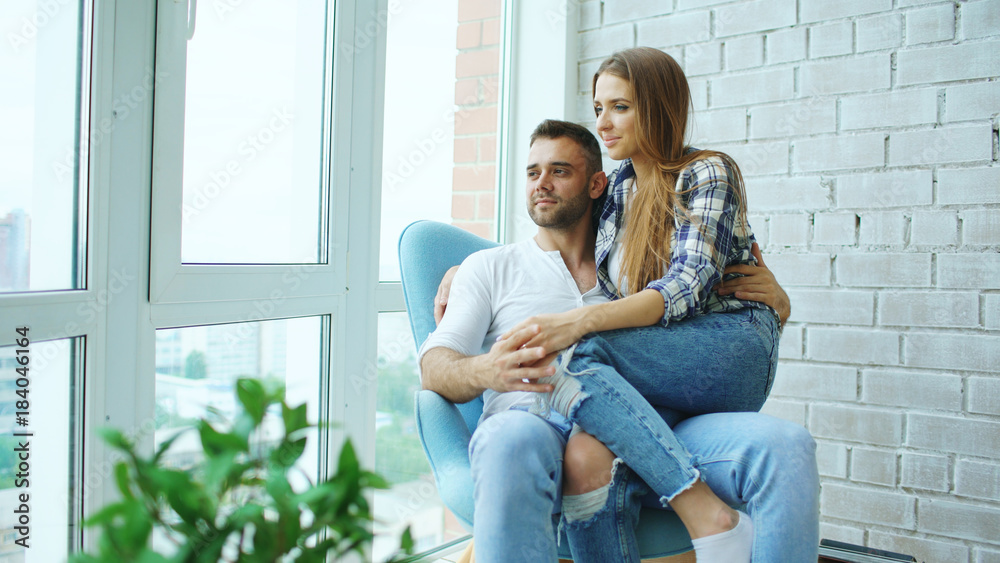 Beautiful young couple relax sitting on chair and enjoying view from ...