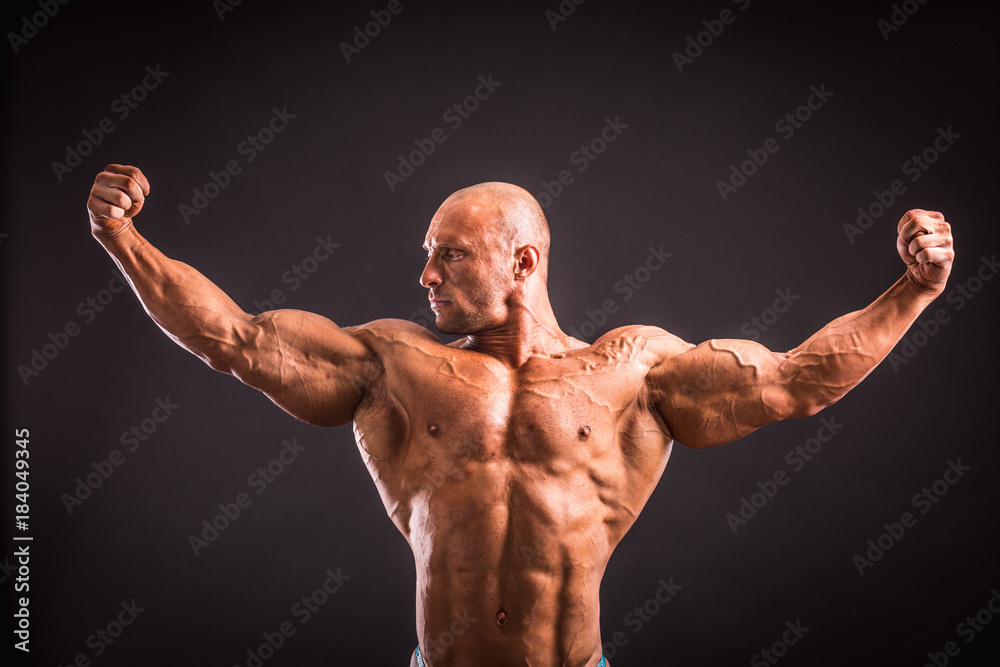 bodybuilder posing in studio Stock Photo | Adobe Stock