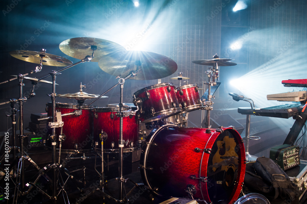 drum set on stage and light background; empty stage with instruments ...