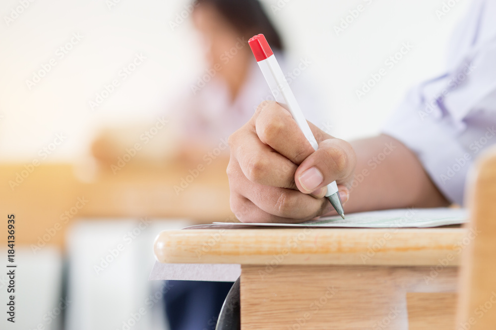 Uniform School Asian students taking exams writing answer optical form ...