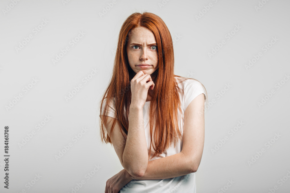 annoyed female with freckles and pursed lips having disappointed ...