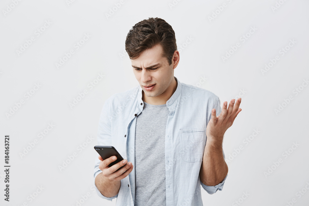 Confused shocked emotional young caucasian male student having puzzled ...