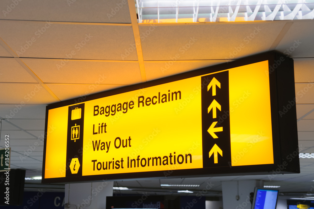 Airport sign giving directions to baggage reclaim, lift, way out and ...