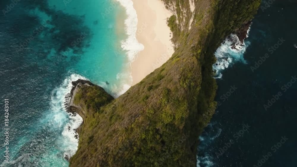 Wild tropical beach at the foot of the cliff. Tropical beach among ...