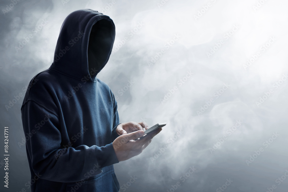 Hacker using mobile phone Stock Photo | Adobe Stock