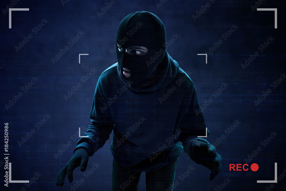 Masked thief caught on security cameras Stock Photo | Adobe Stock