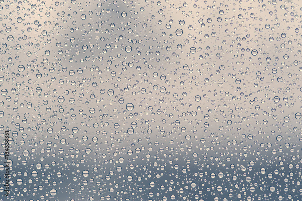 Multiple water drops or raindrops of different sizes on a transparent ...