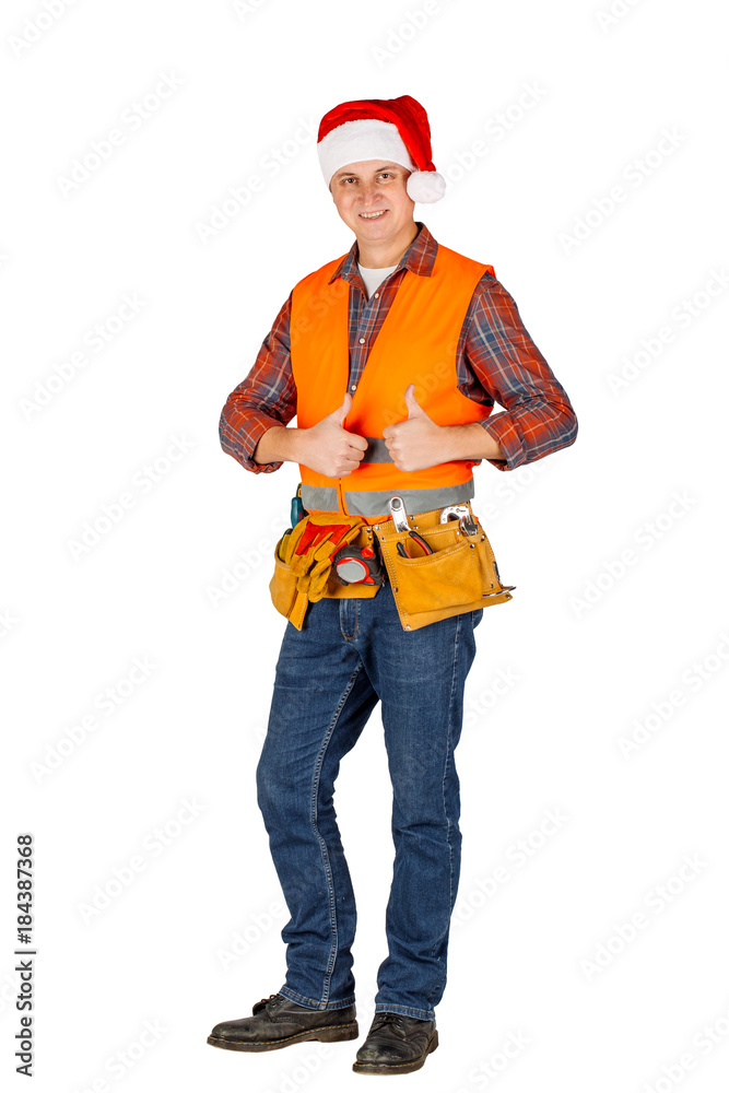 Full length portrait of a male builder in a santa hat over white wall ...