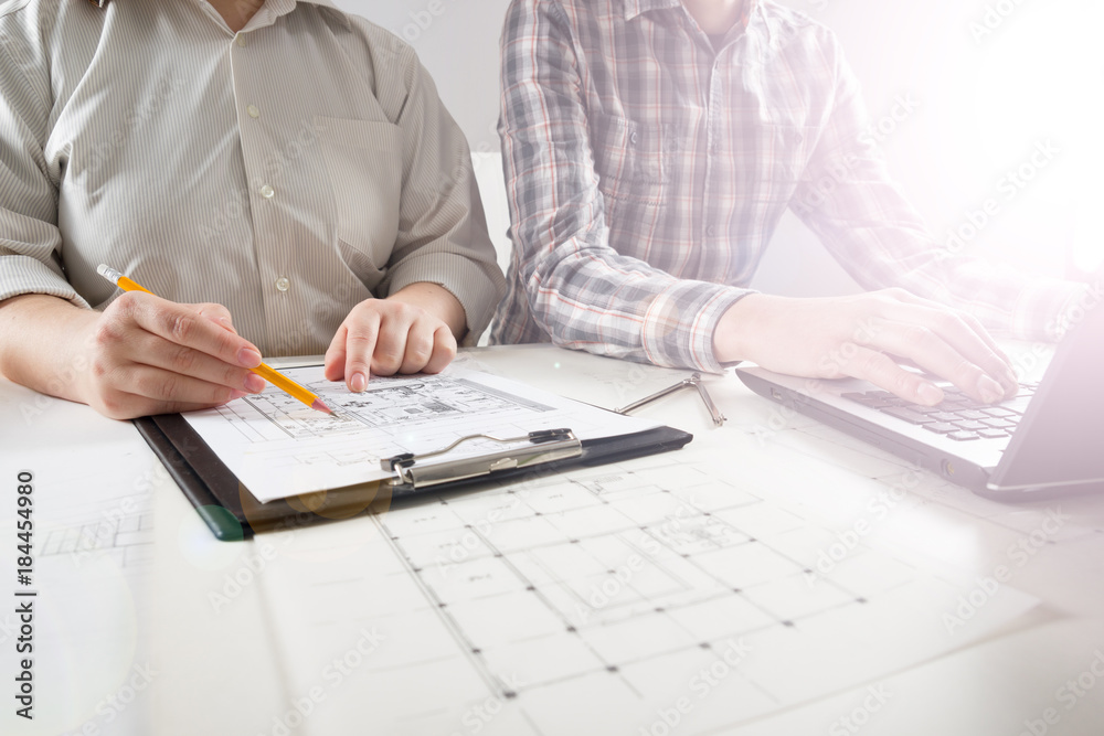 Architects working on blueprint, real estate project. Architect ...