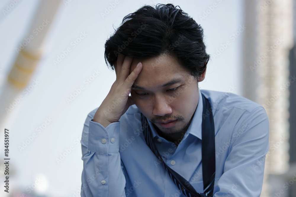 Frustrated stressed young Asian man touching face with hands feeling ...