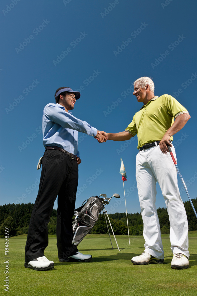 Golfer and caddy shaking hands Stock Photo | Adobe Stock