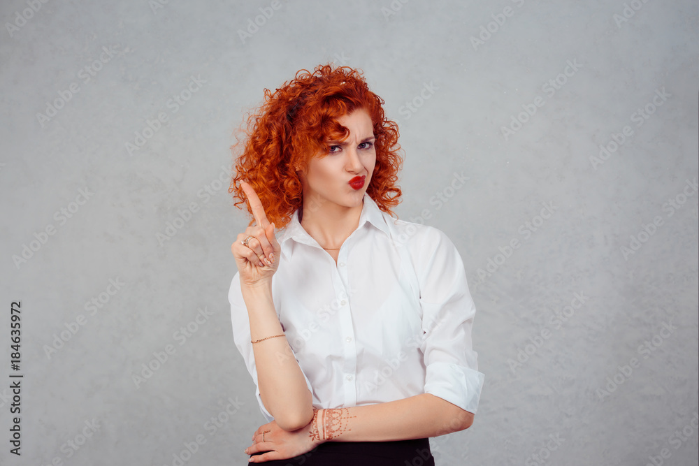 woman gesturing a no sign. portrait unhappy, serious redhead curly ...