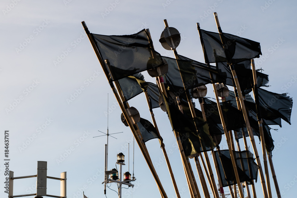 Fishing port, flags fluttering on stilts on fishing nets. Fishing nets ...