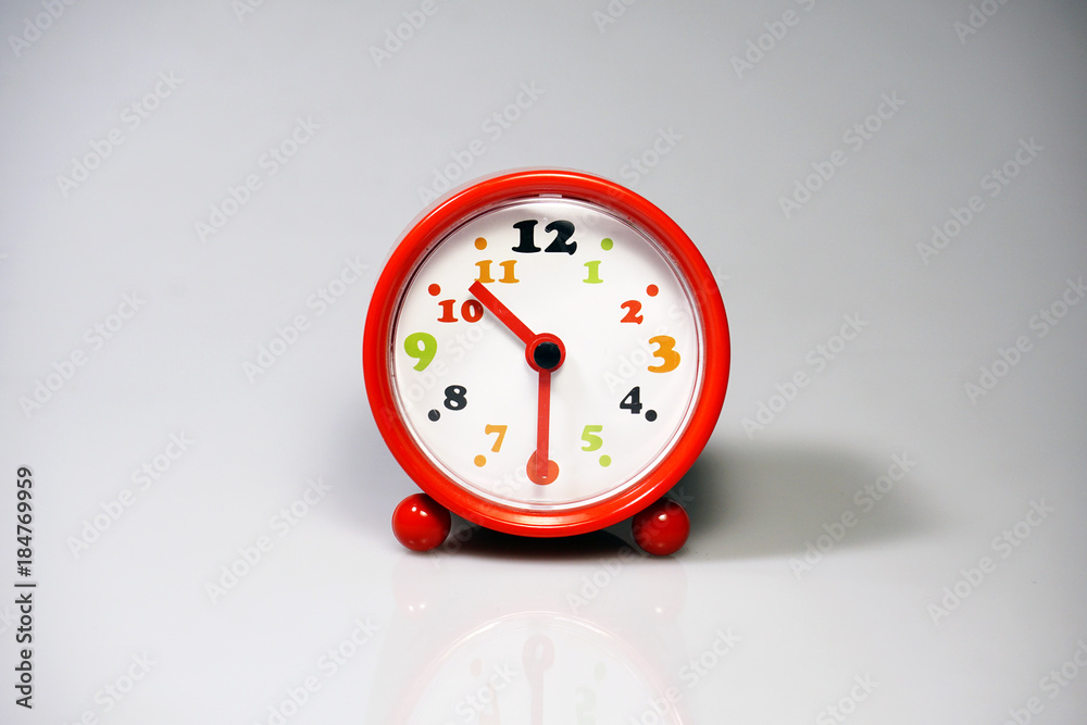 Red alarm clock with time shows 10.30 o'clock with reflections on ...