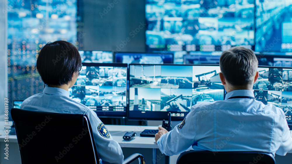 Poster In the Security Control Room Two Officers Monitoring Multiple ...