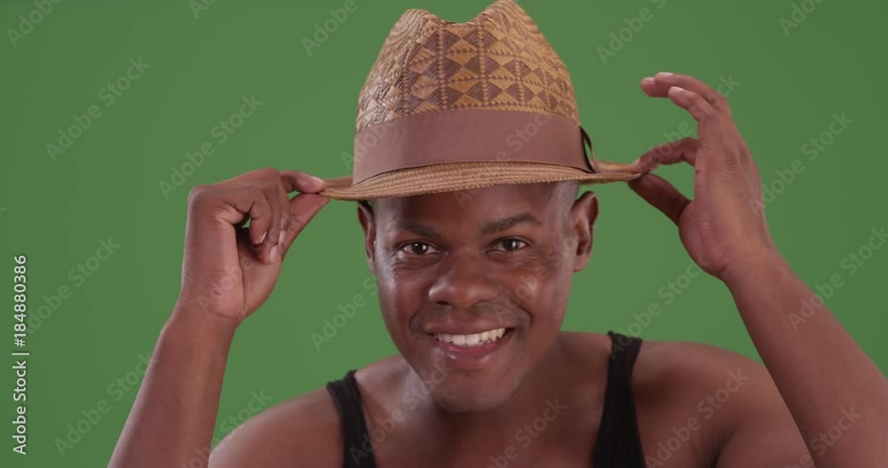 Black man poses happily for a portrait on green screen. On green screen ...