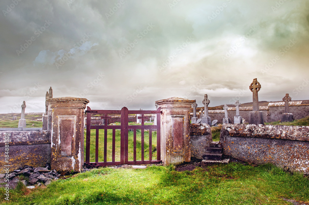 Entrance to the cemetery with metal gates and concrete fence Stock ...
