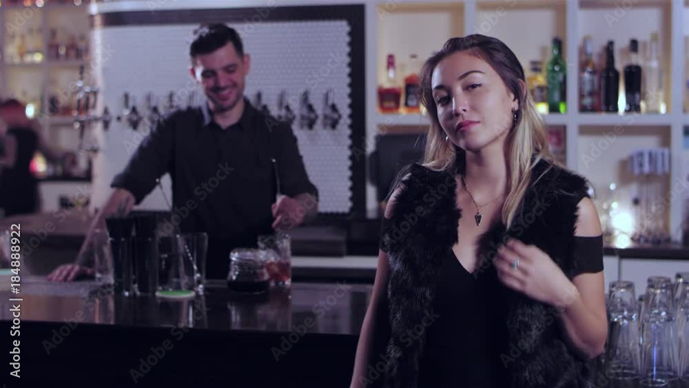 Portrait shot of a young attractive Asian woman runs her fingers through her hair, and flirts ...