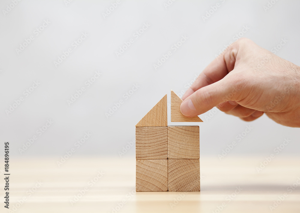 Hand building house with wooden blocks Stock Photo | Adobe Stock