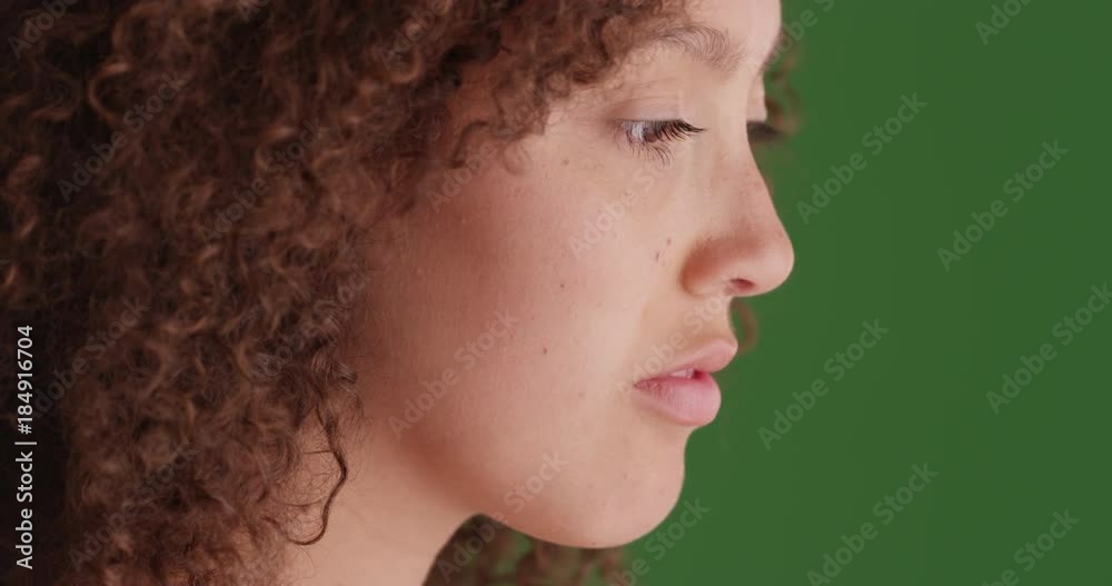 Black girl poses for a portrait on green screen. On green screen to be ...