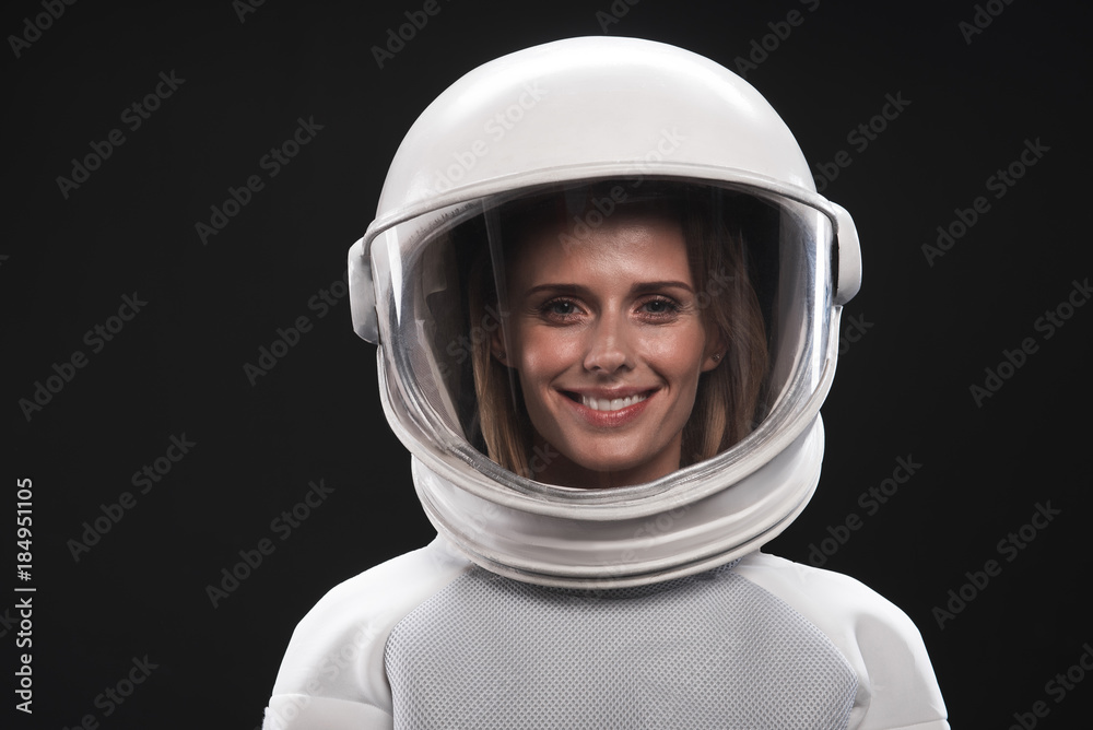Feeling happiness. Portrait of charming delighted female astronaut ...