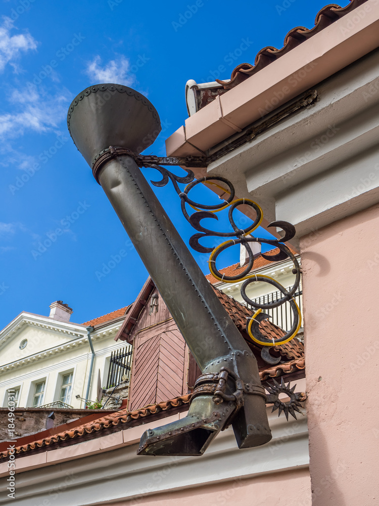 Tallinn old medieval town long leg street symbol, a gutter in the shape ...
