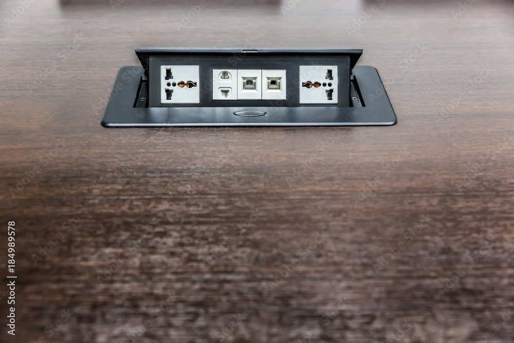 Electrical outlet and network plug on table Stock Photo | Adobe Stock