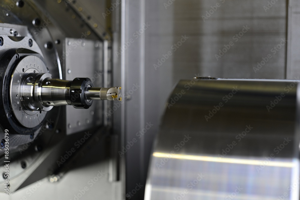 The 5-axis CNC machine while cutting the sample part of turbine.The ...