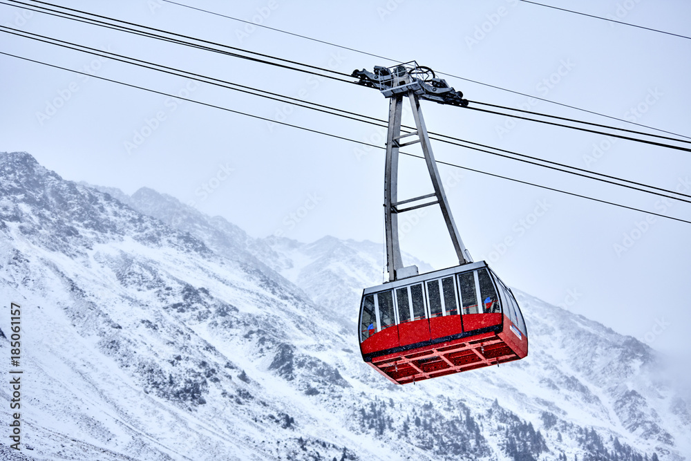 Red cable car in the background of the winter mountains. Old red cable ...