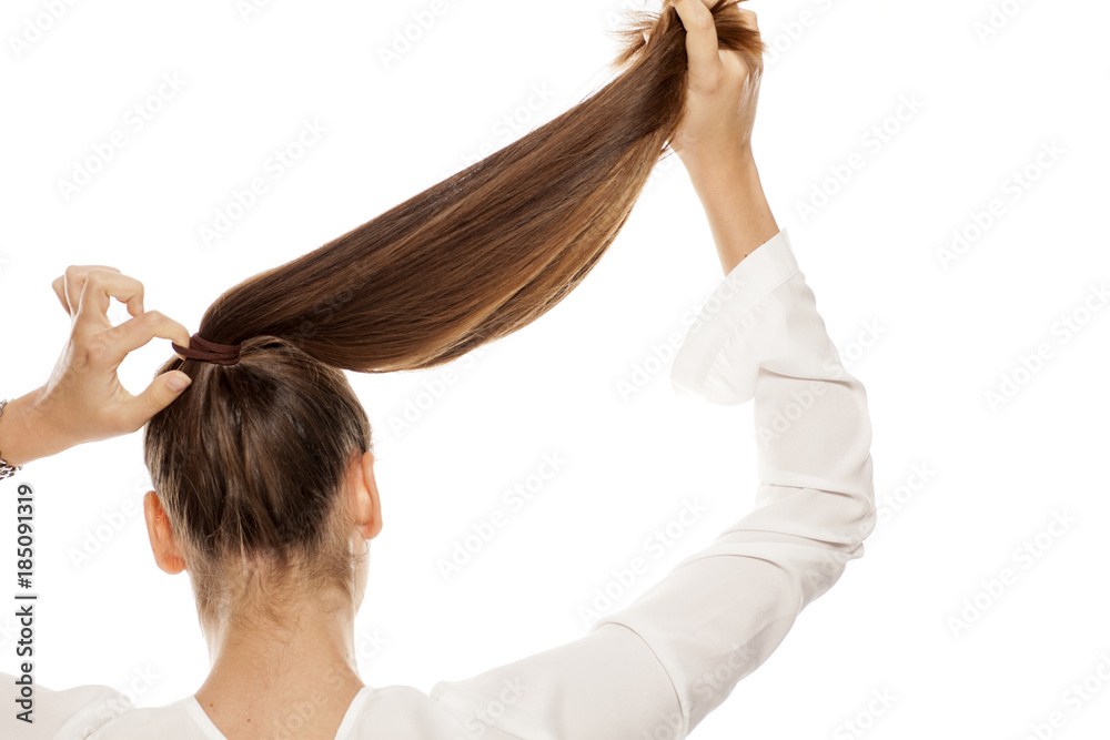 Back view of women that tightens the hair in a ponytail Stock Photo ...