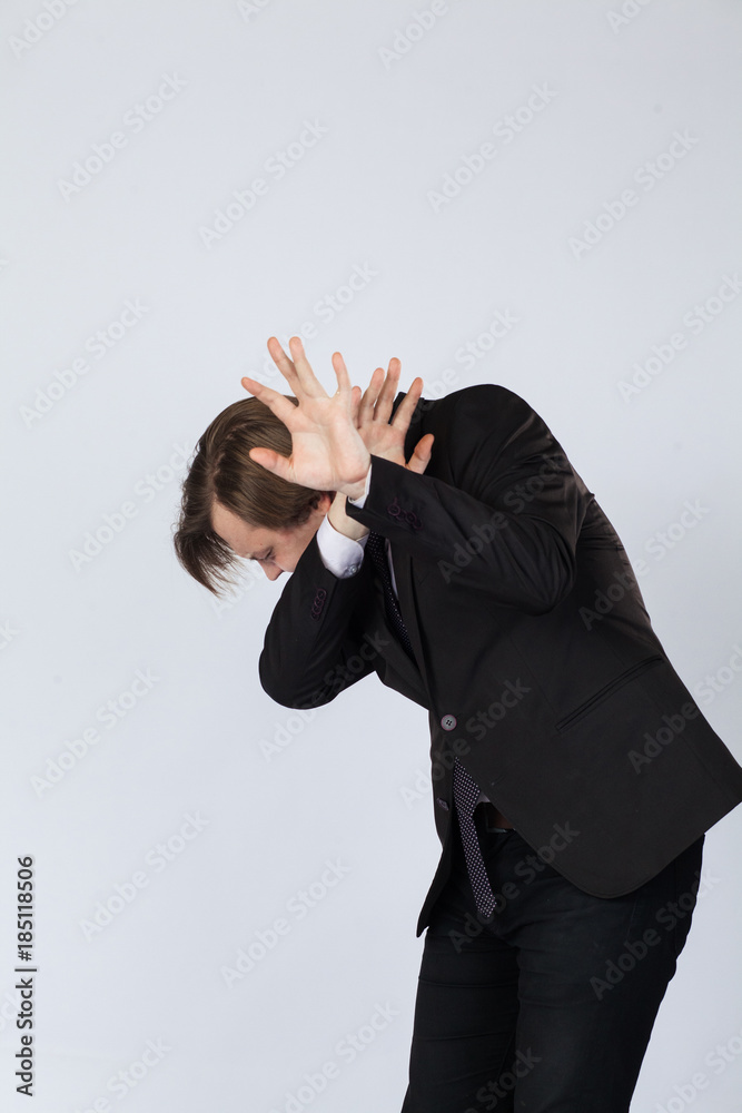 Male protecting face from violent attack. Adult caucasian man covering ...