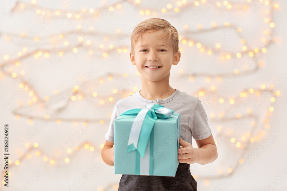 Cute little boy with gift for Mother's Day on blurred background Stock ...