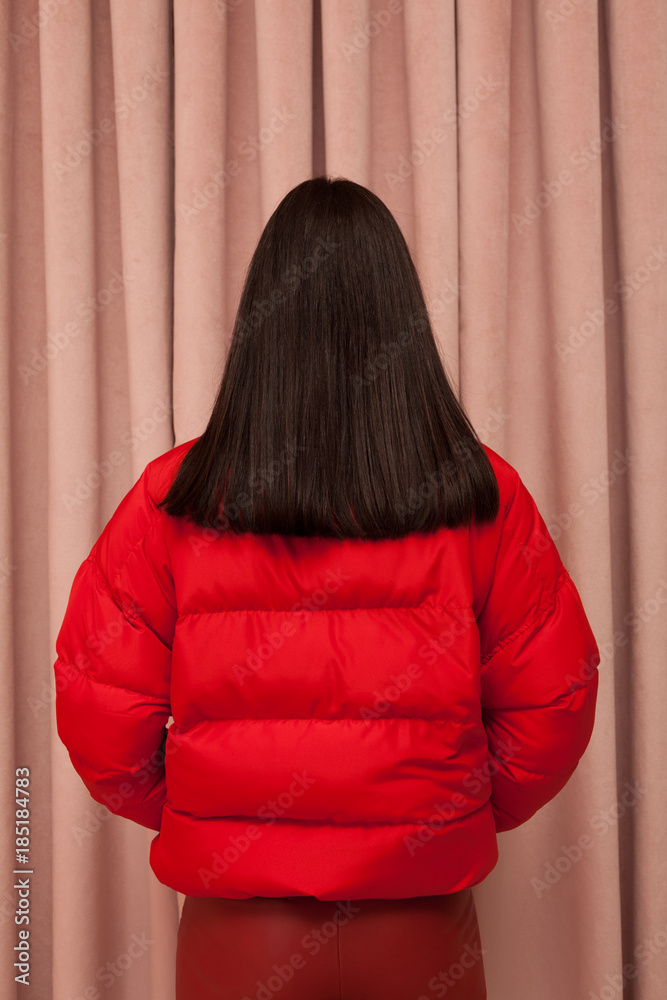 Back view of a woman with red puffer jacket Stock Photo | Adobe Stock