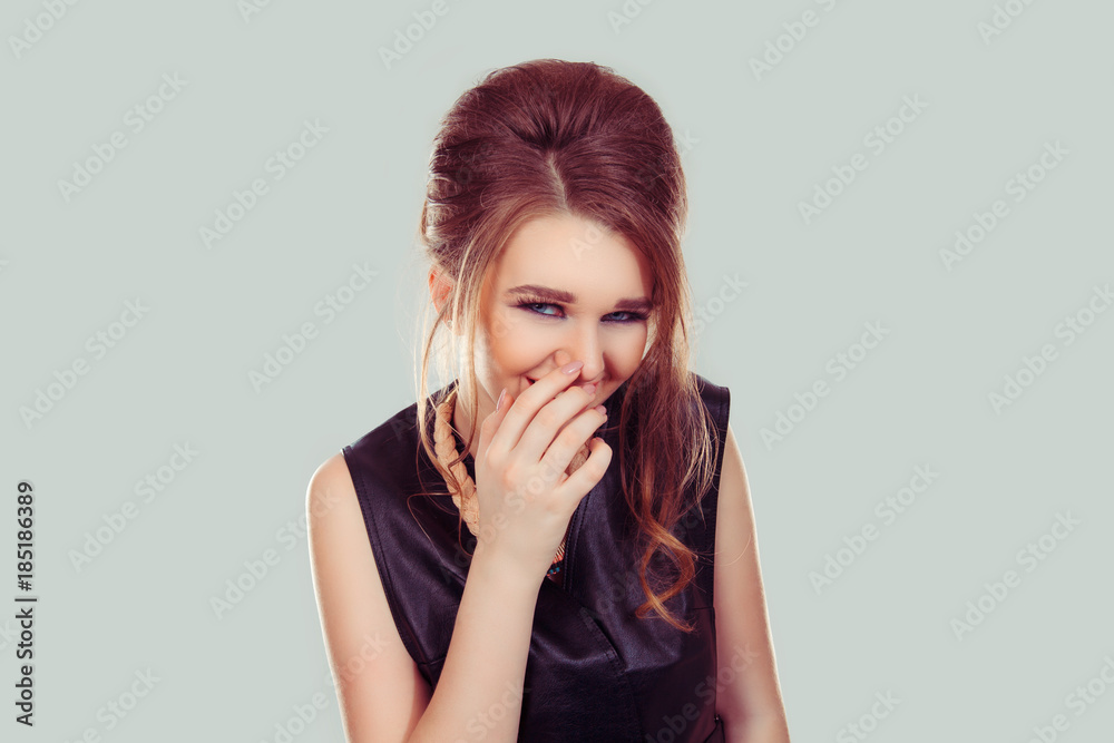 Laughing shy. Beautiful woman smiling hand on face isolated light green ...