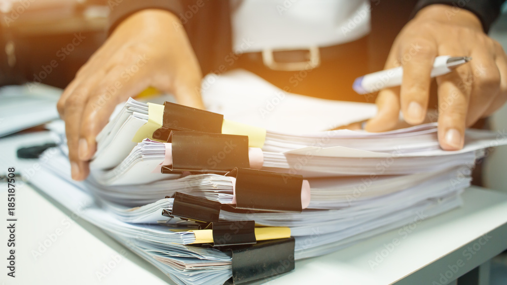 Businesswoman hands working on Stacks of documents files for finance in ...