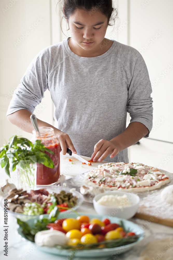 Young Girl Making Pizza / Cooking in Kitchen Stock Photo | Adobe Stock
