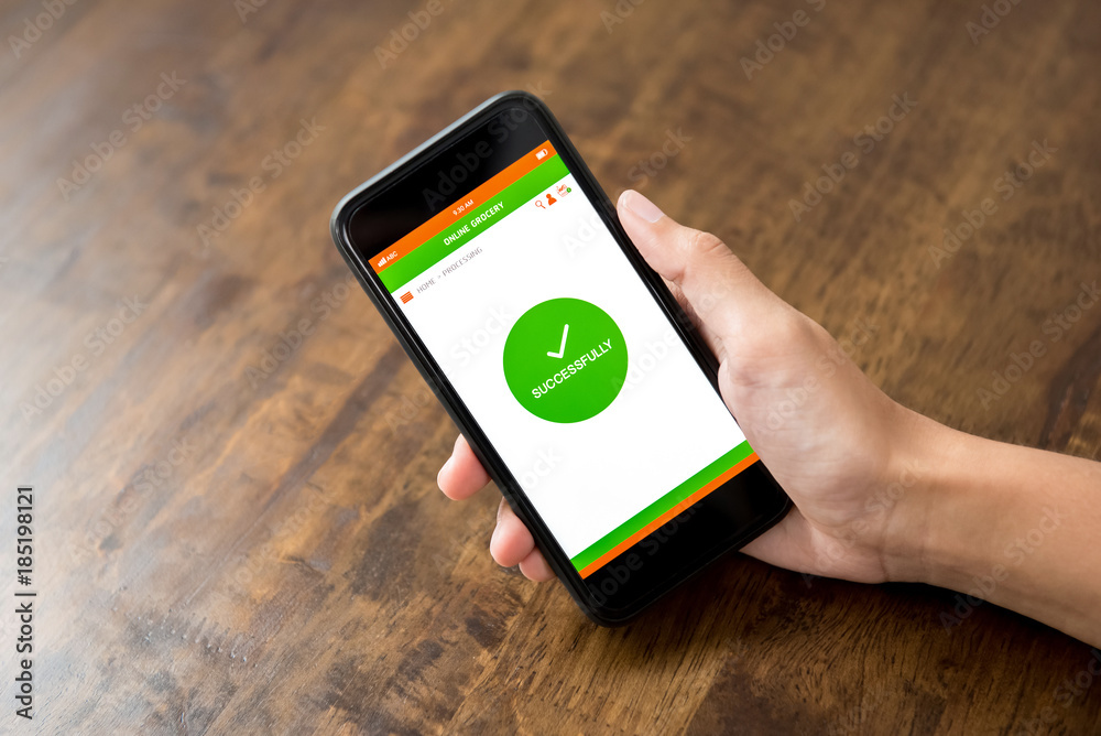 Hand holding smartphone showing successfully confirmation text on ...