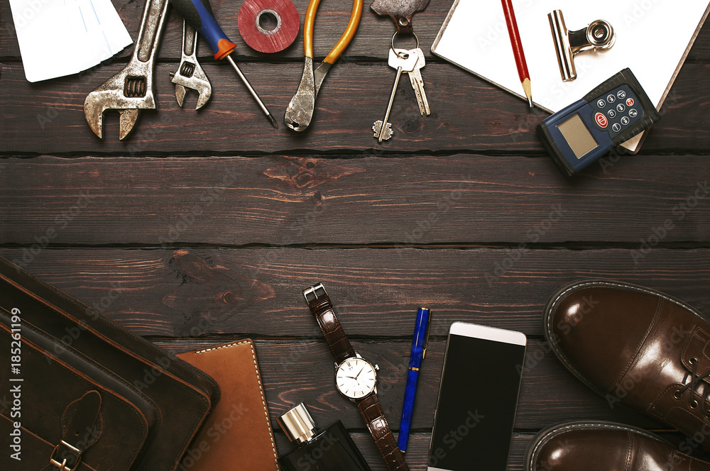 Top view, men's personal items and tools with space on a dark wooden ...
