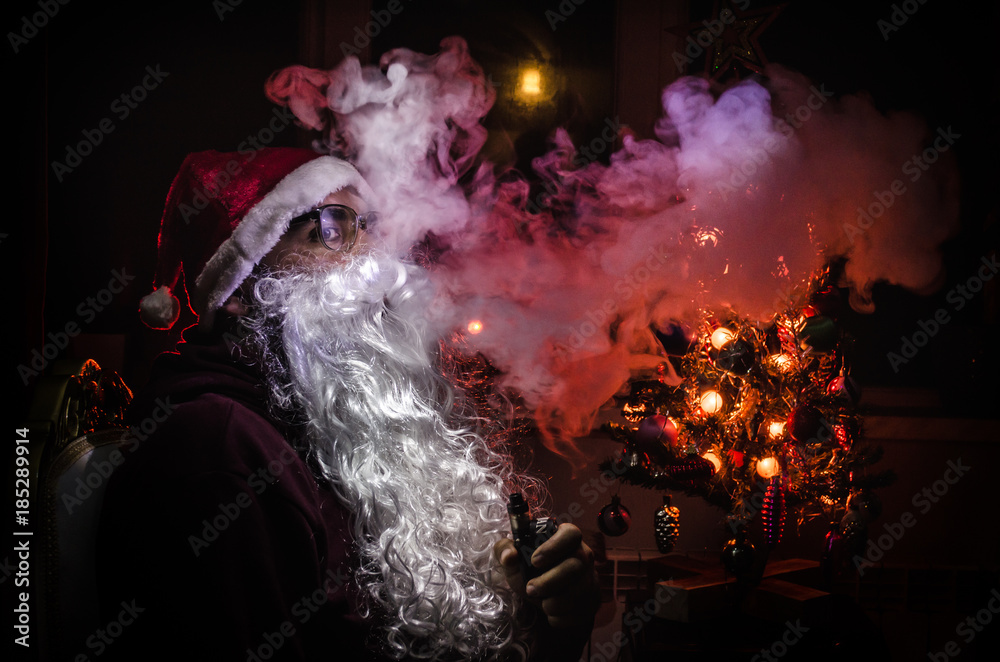 Santa Clause vaping electronic cigarette dressed as traditional Santa ...