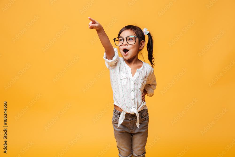 Happy excited little girl child pointing. Stock Photo | Adobe Stock