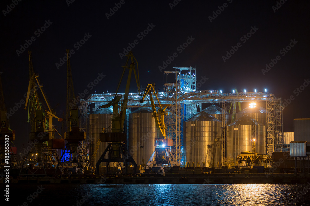 Port grain elevator in night time. Industrial sea trading port bulk ...