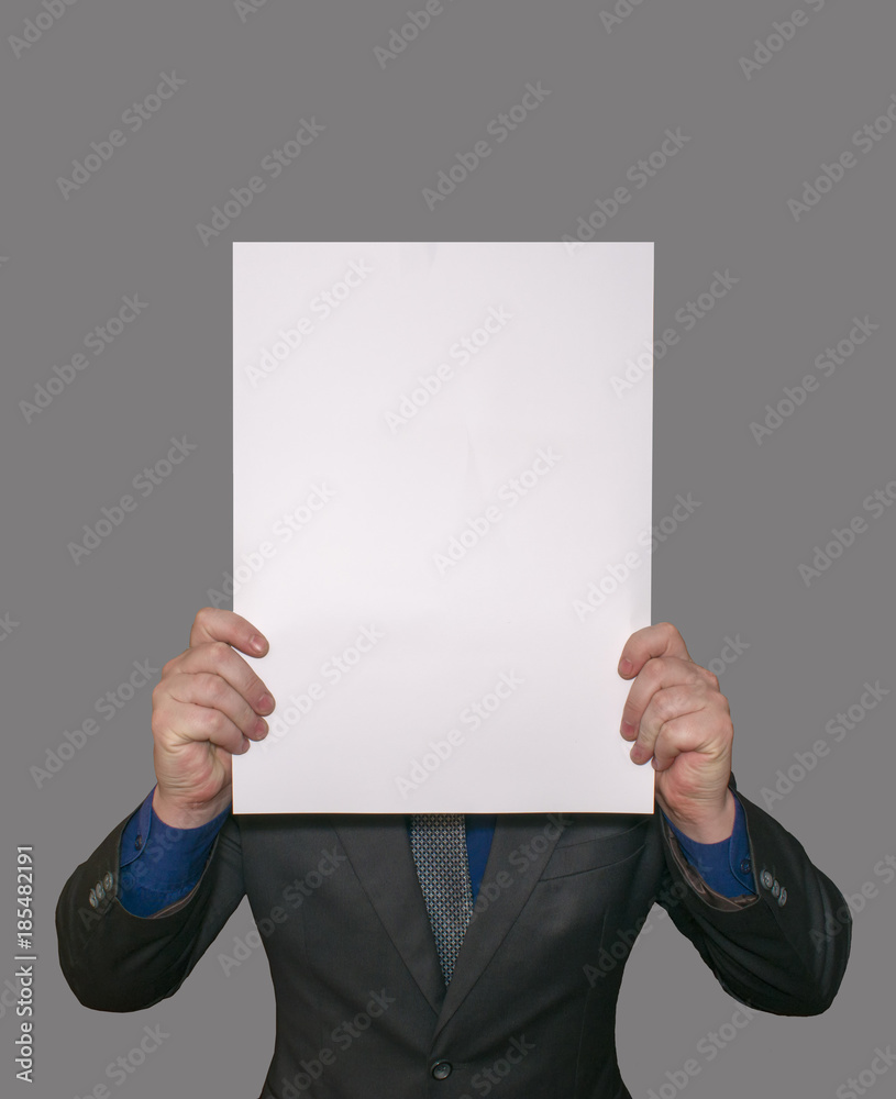 A man shows an empty white large A3 A2 paper, covering his face ...