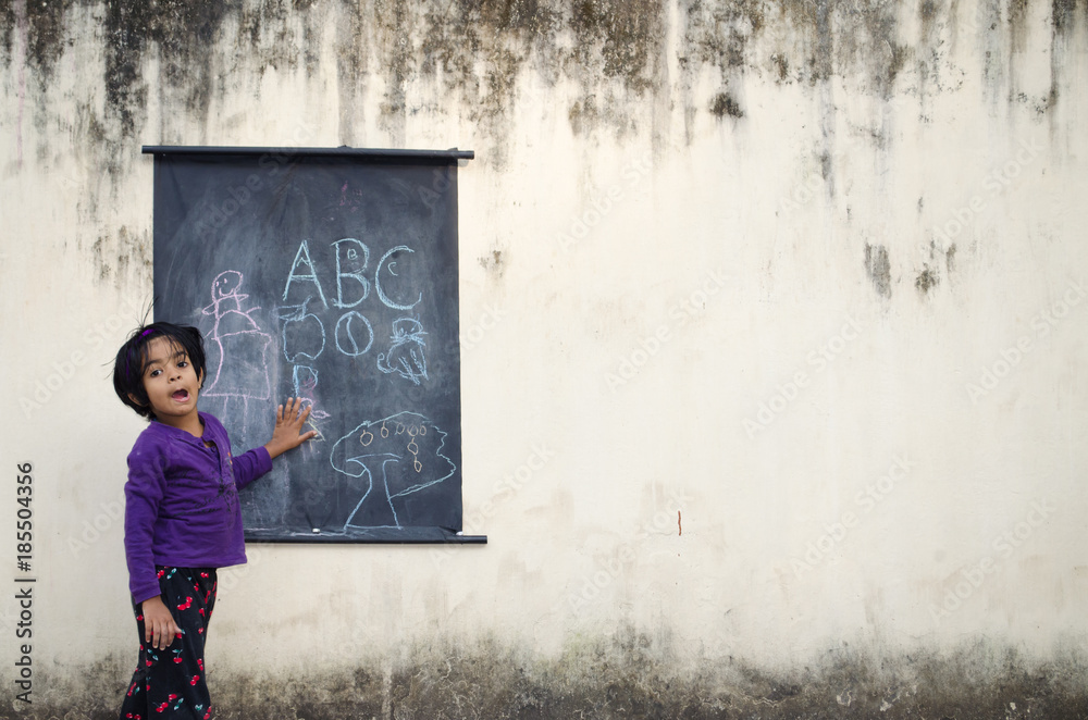 Indian child learning ABC alphabets by writing on a blackboard Stock ...