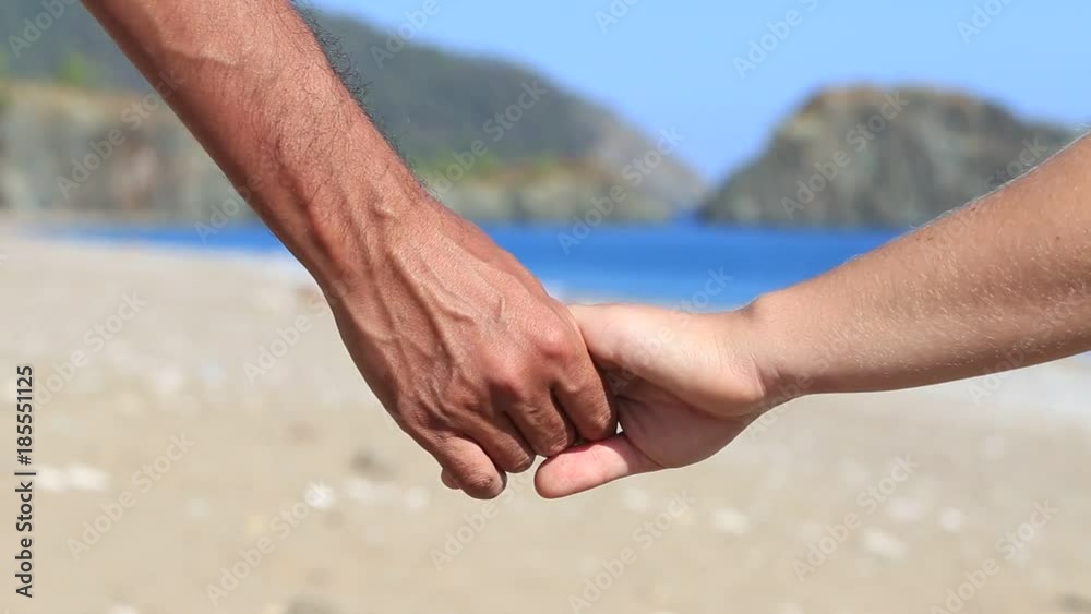 Affectionate boyfriend and romantic girlfriend holding hands, showing ...