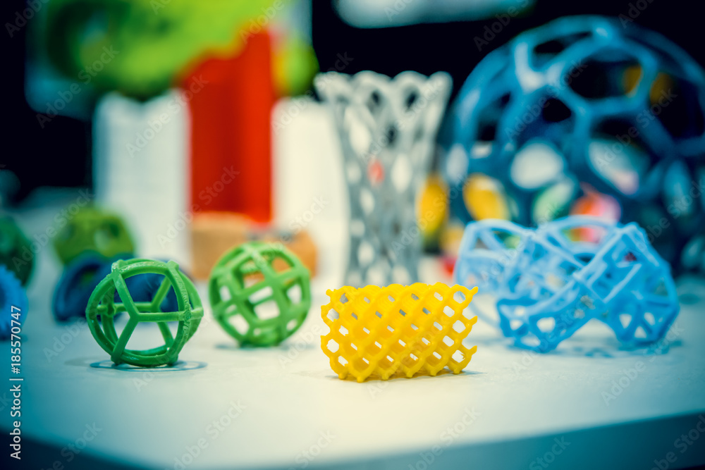 Many abstract models bright colorful objects printed on a 3d printer on ...